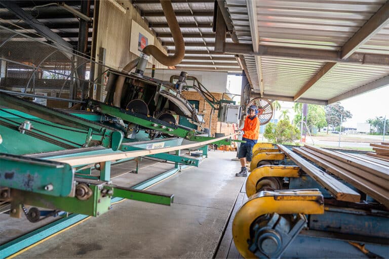 Nortruss-Hardware-Machining-Person-Placing-Timber | Nortruss Hardware